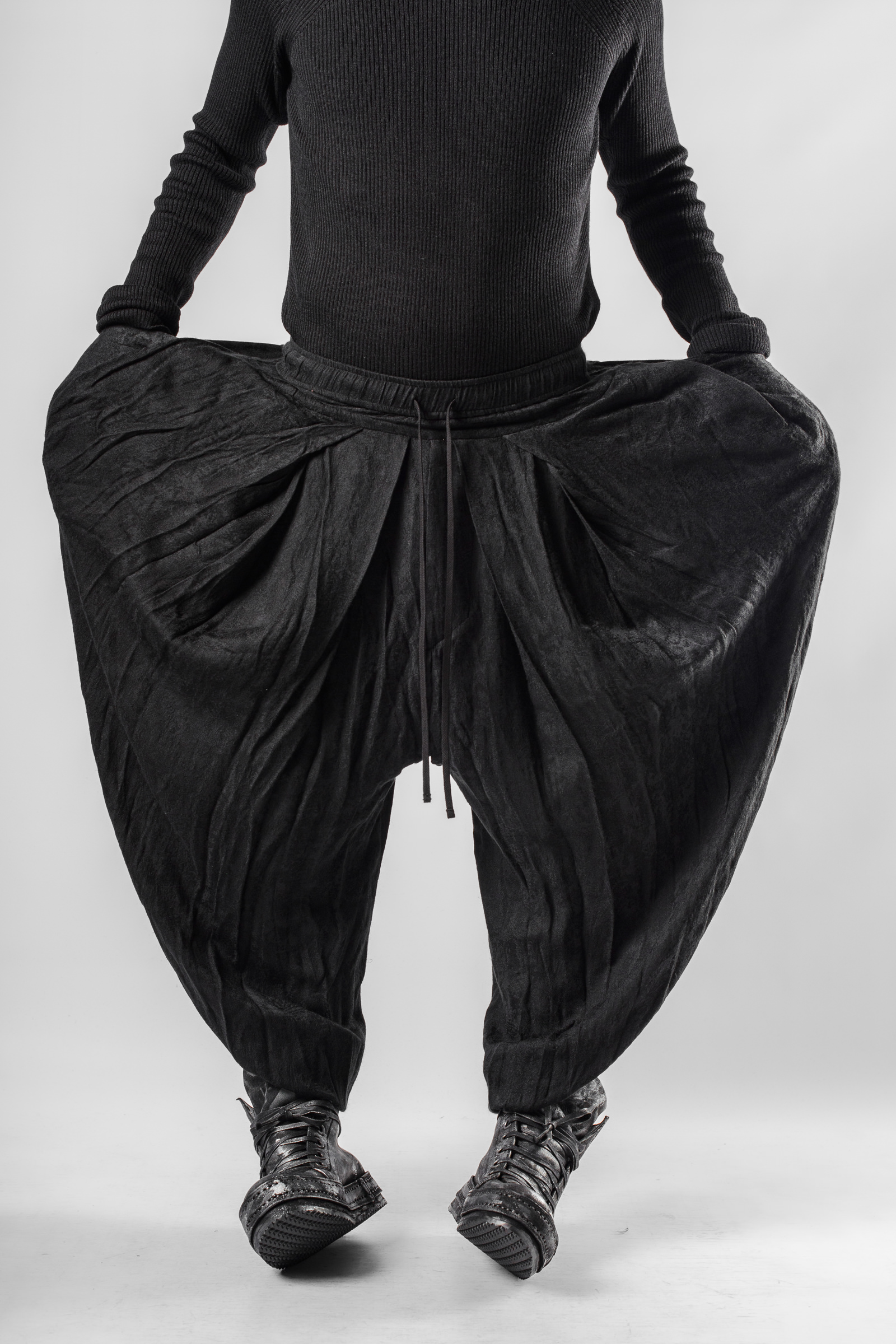 JULIUS_7 Loose Draped Trousers in color Black | Elixirgallery